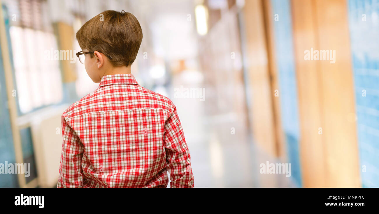 Handsome toddler child with green eyes backside, rear view at school ...