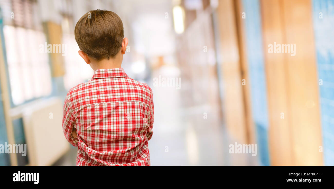Handsome toddler child with green eyes backside, rear view at school ...