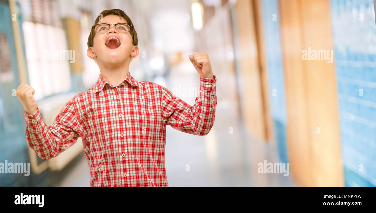 Handsome toddler child with green eyes happy and excited expressing ...