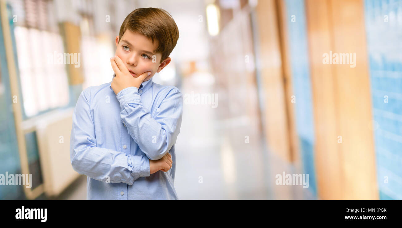 Handsome toddler child with green eyes scared in shock, expressing ...