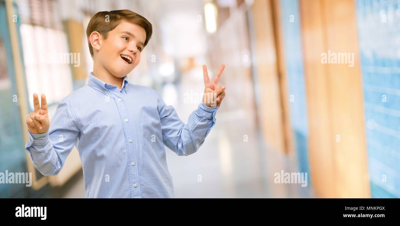 Handsome toddler child with green eyes happy and excited expressing ...