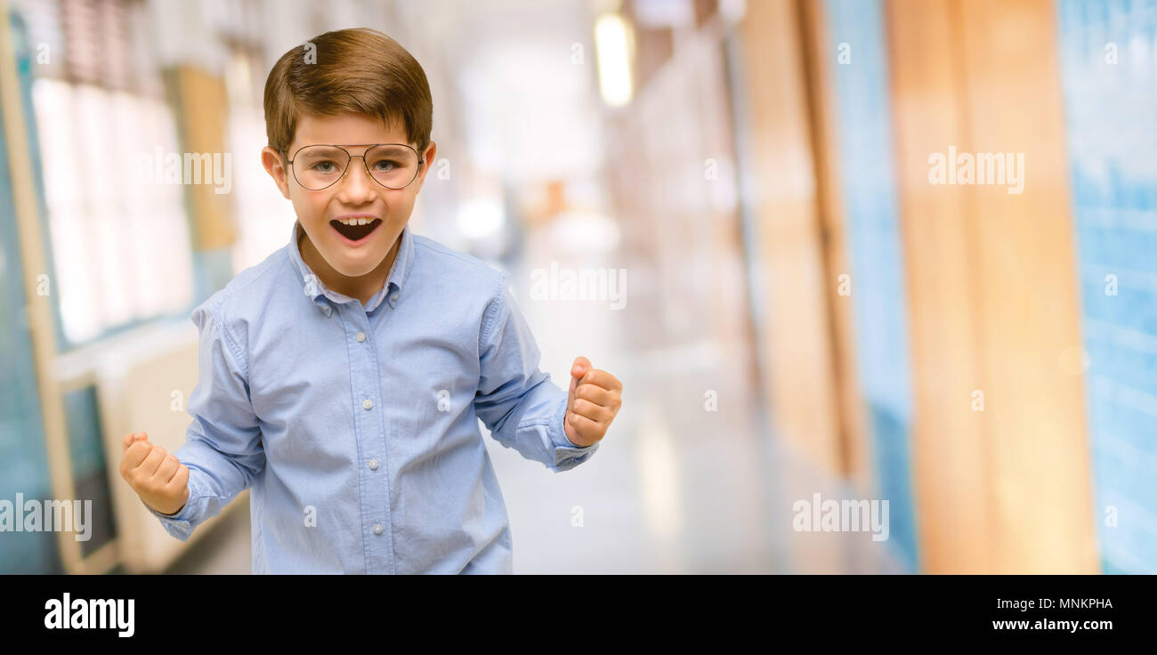 Handsome toddler child with green eyes happy and excited celebrating ...