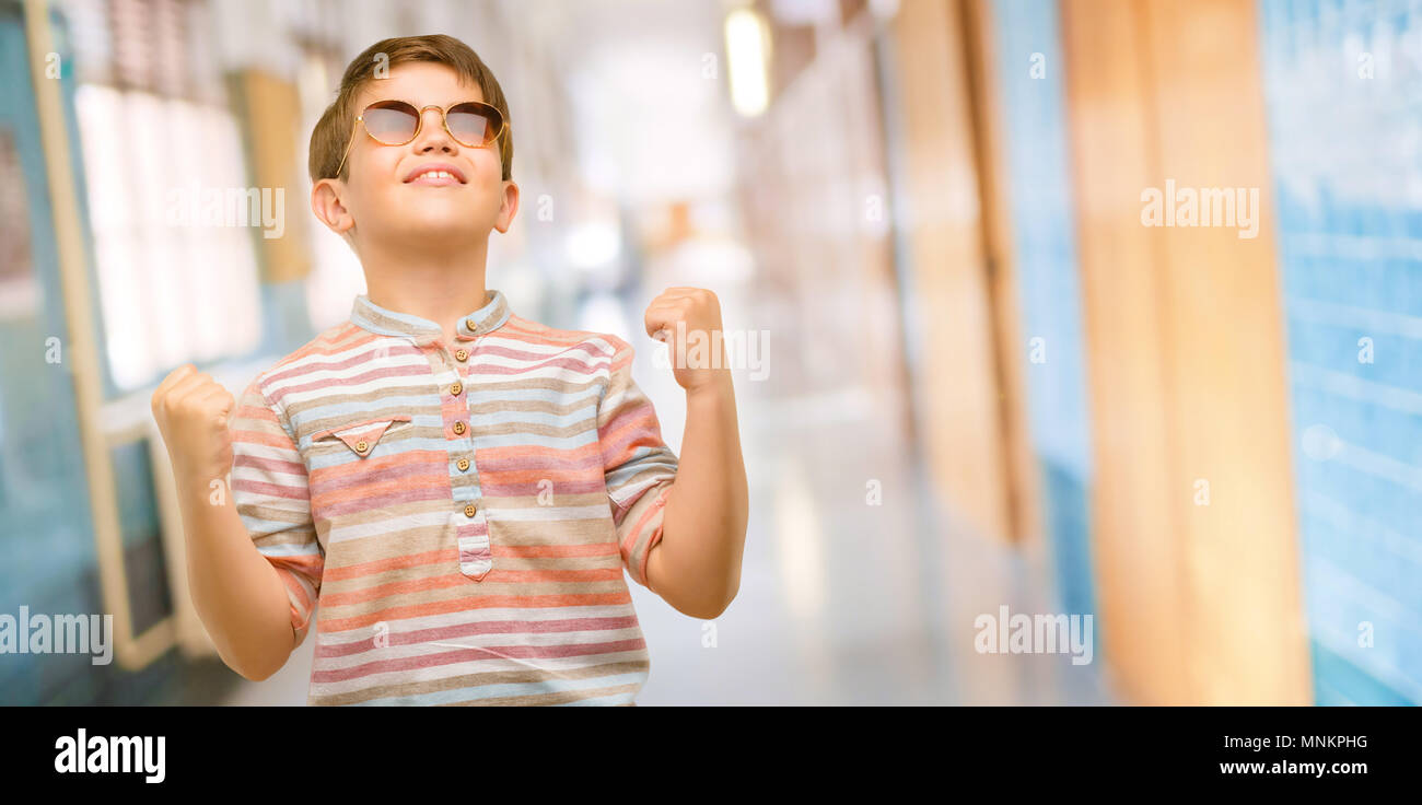 Handsome toddler child with green eyes happy and excited celebrating ...