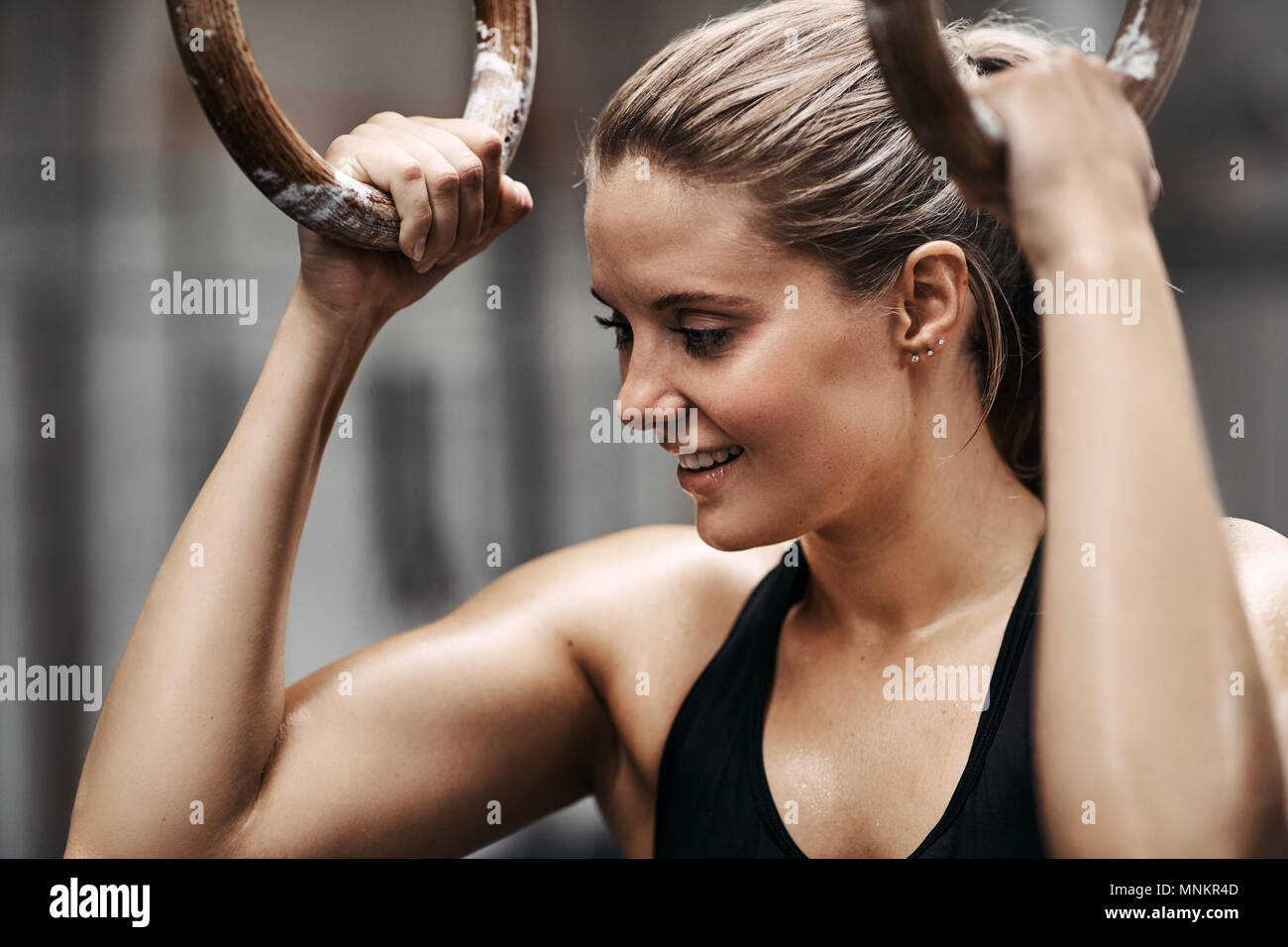 Fit young woman in sportswear smiling and working up a sweat during an ...