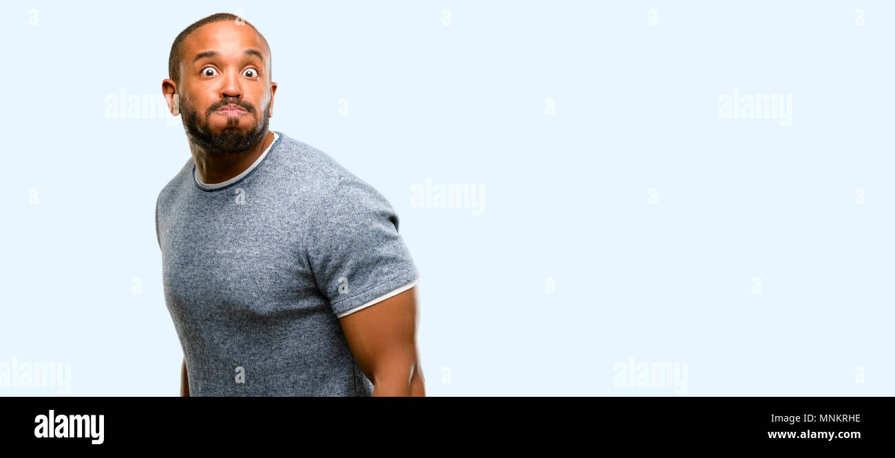 African american man with beard puffing out cheeks, having fun making ...