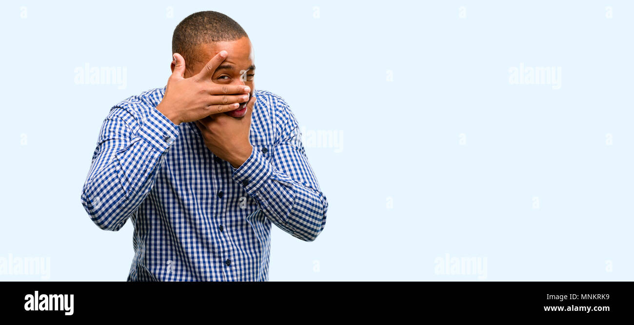 African american man with beard smiling having shy look peeking through ...