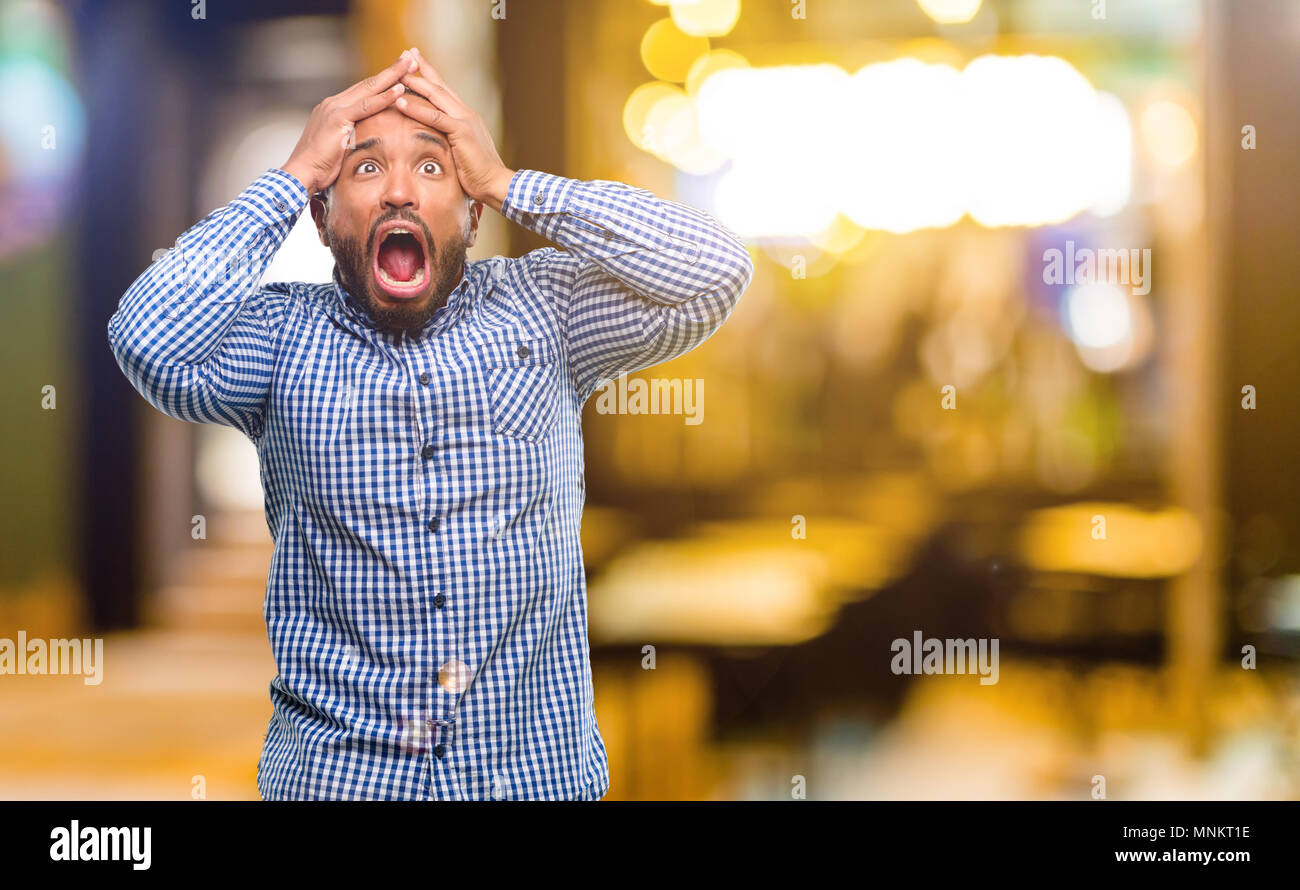 African american man with beard stressful keeping hands on head ...