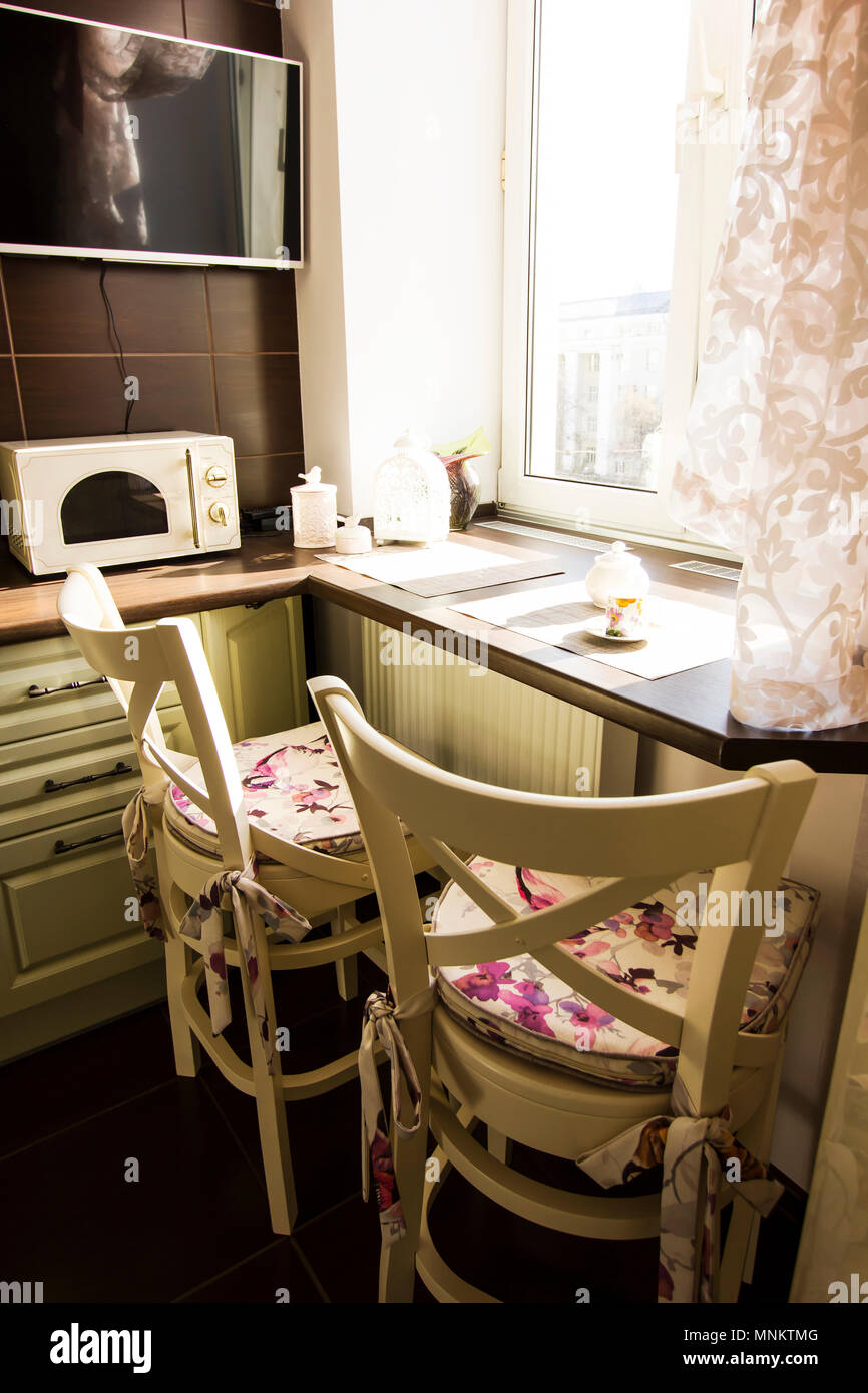 Kitchen interior in bright colors stove refrigerator chairs, classic ...