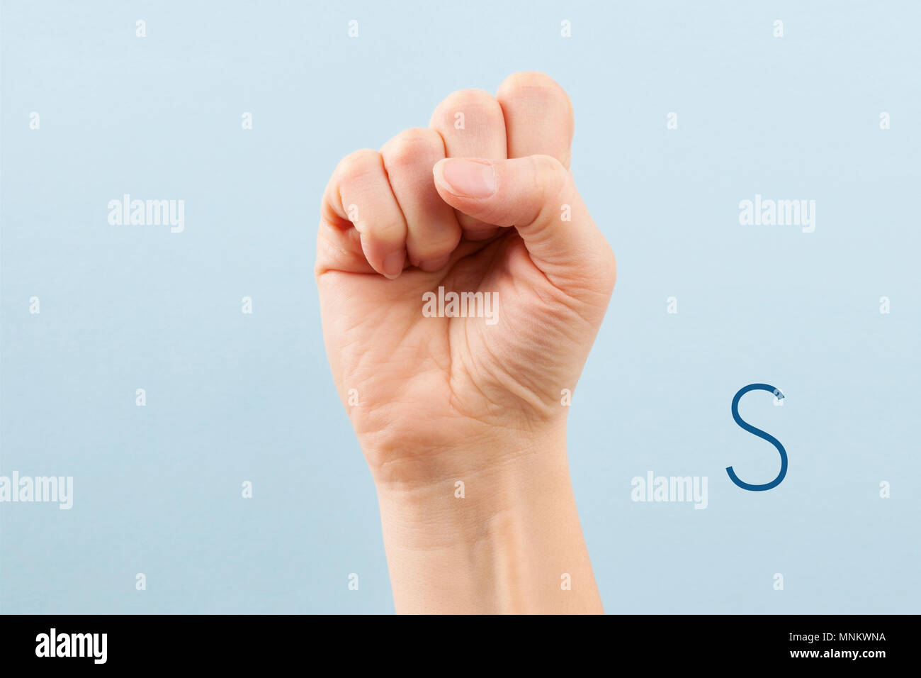 American sign language. Female hand showing letter S isolated on blue ...