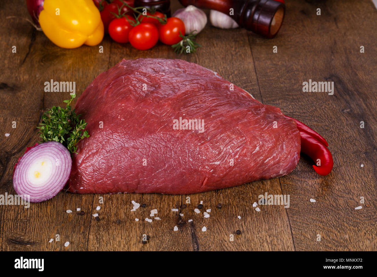 Raw beef meat over the wooden background Stock Photo - Alamy