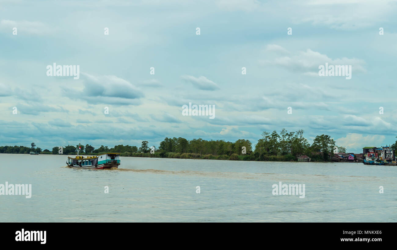 wooden boat cruising on Mahakam river, outback of Borneo, Indonesia ...
