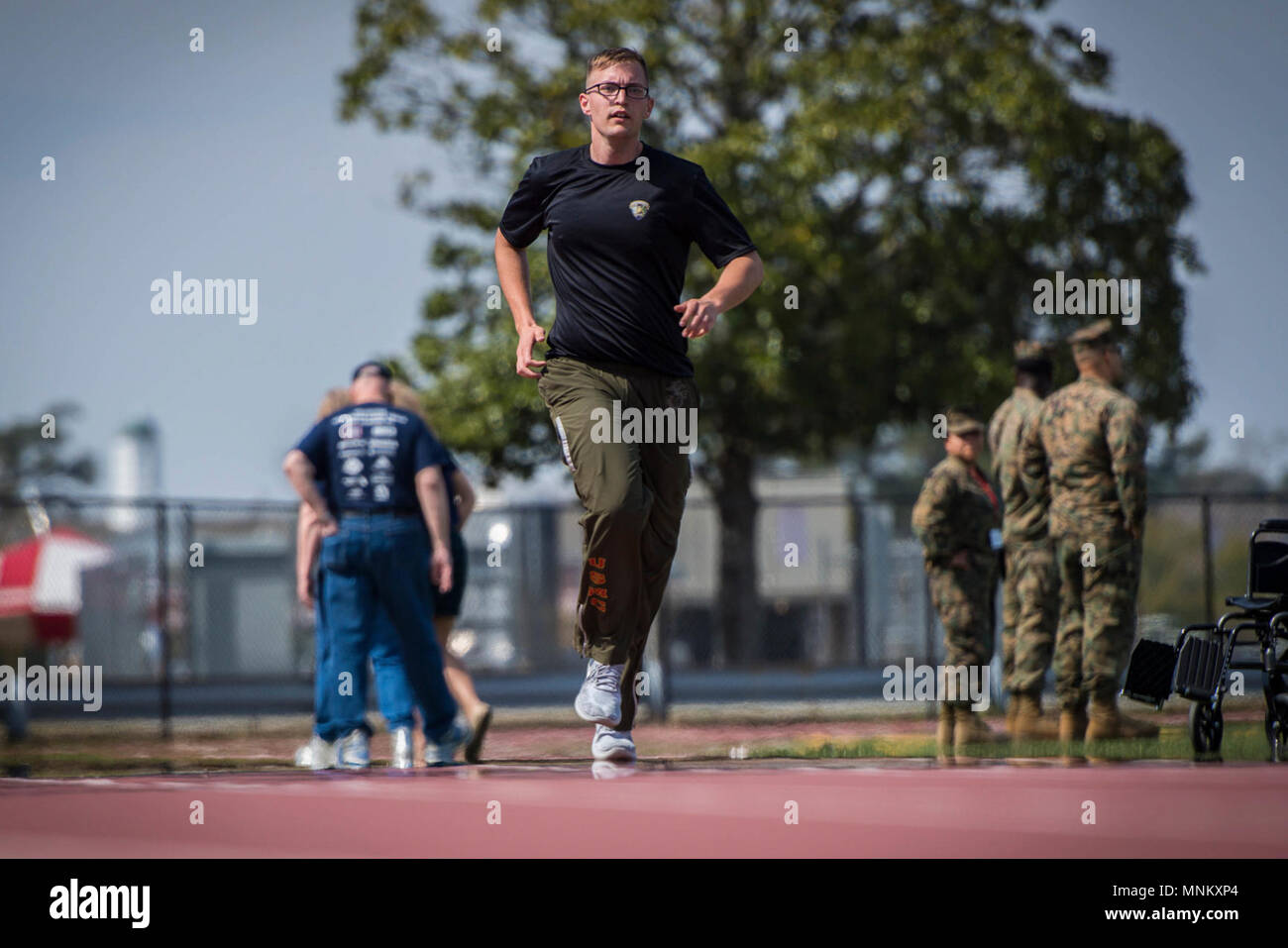 A U.S. Marine runs around the track during a 2018 Marine Corps Trials ...