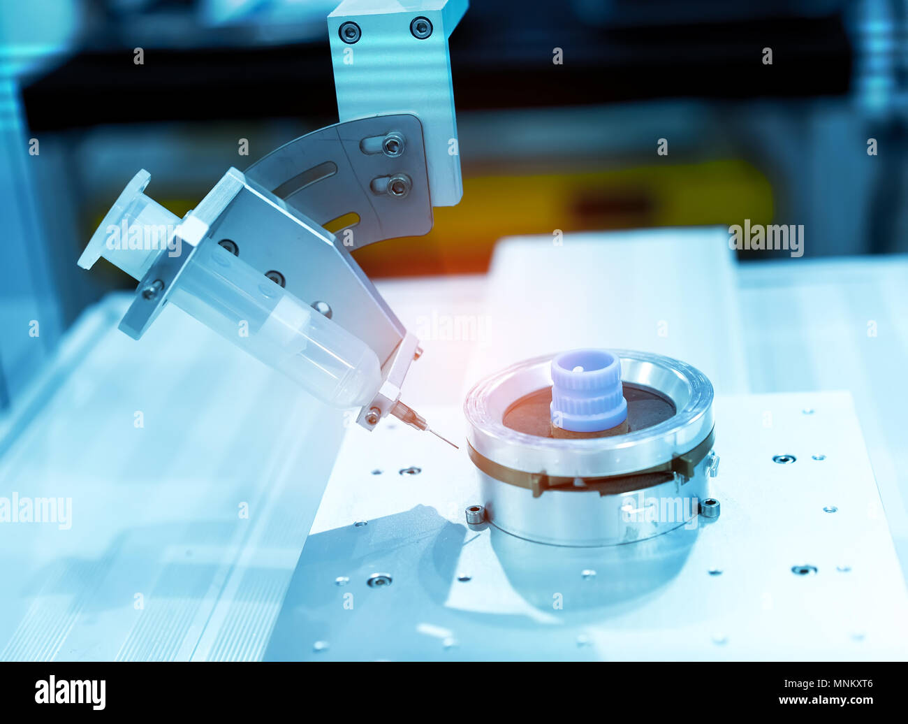 Robot holding glue syringe Injection Stock Photo - Alamy