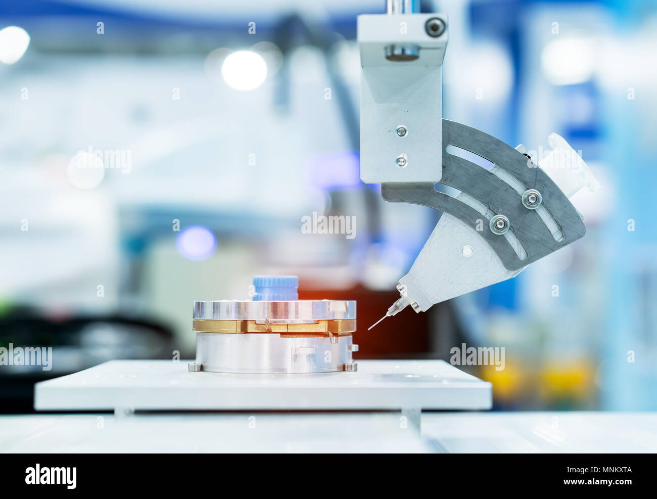 Robot holding glue syringe Injection Stock Photo - Alamy