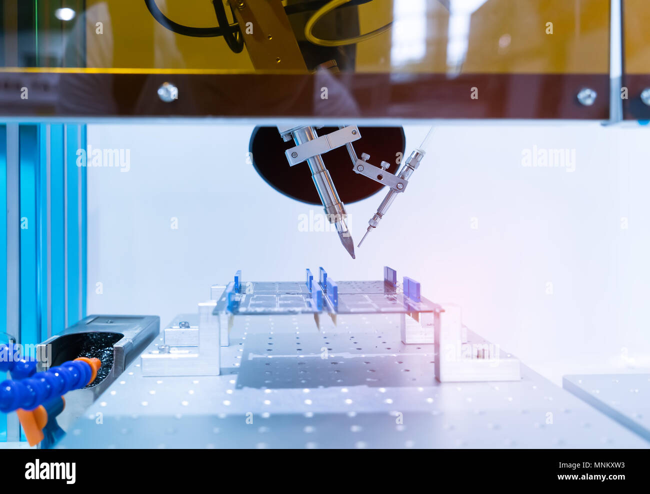 Robot holding glue syringe Injection Stock Photo - Alamy