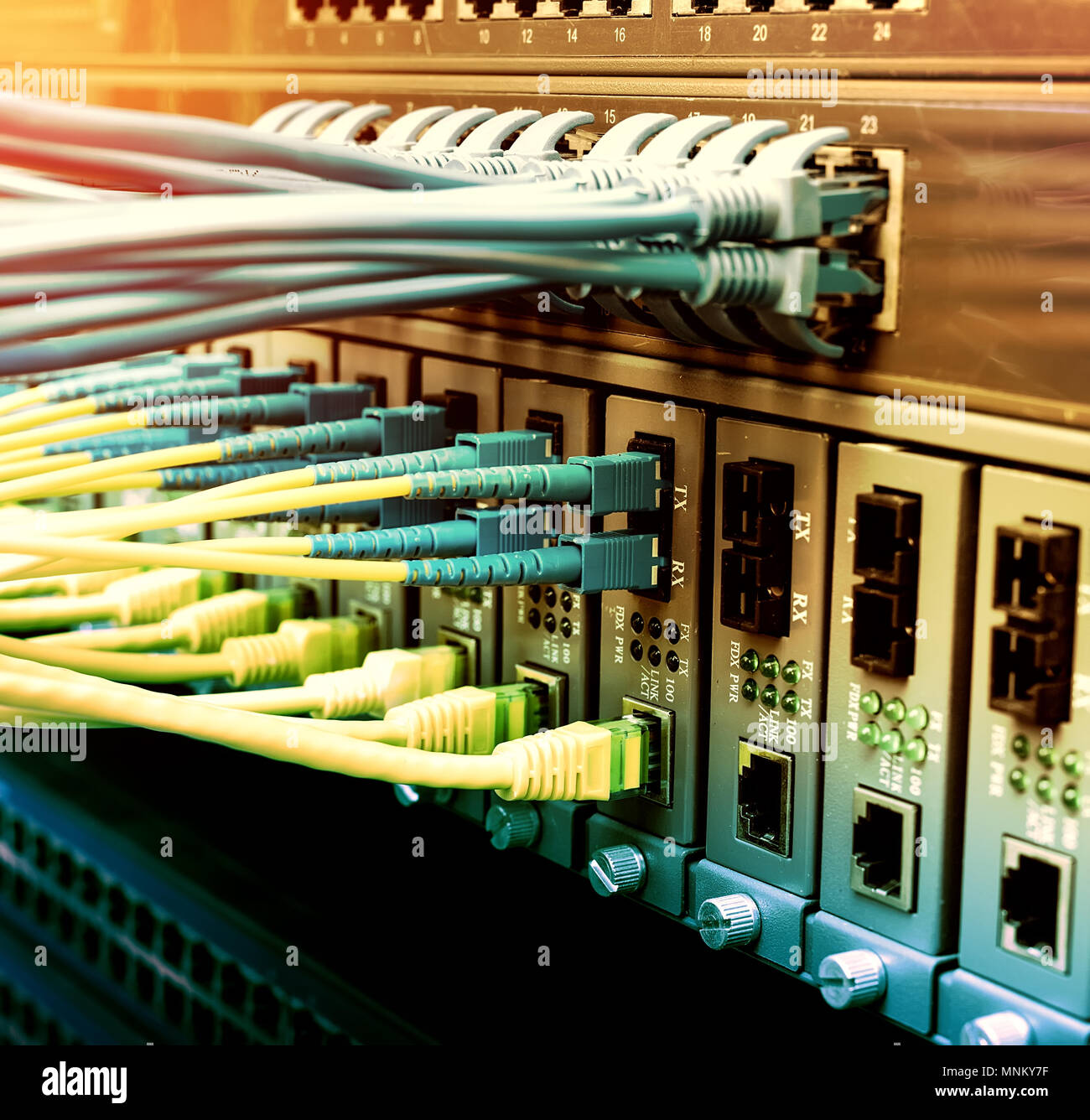 Network cables connected to ethernet ports,Fiber Optic cables connected ...