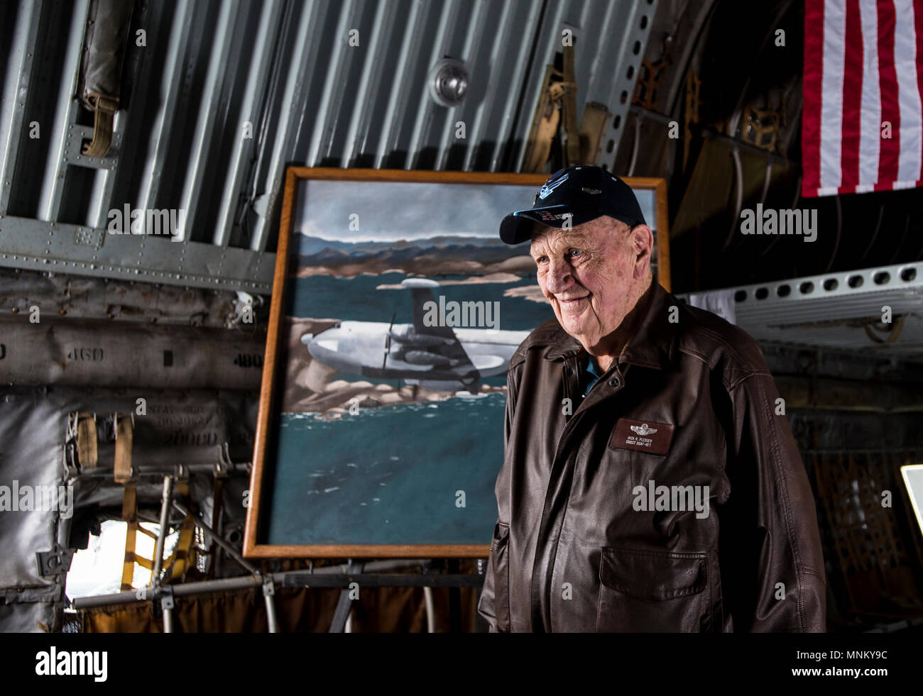 Retired Chief Master Sgt. Jack Pledger greets tour memebers inside of a ...