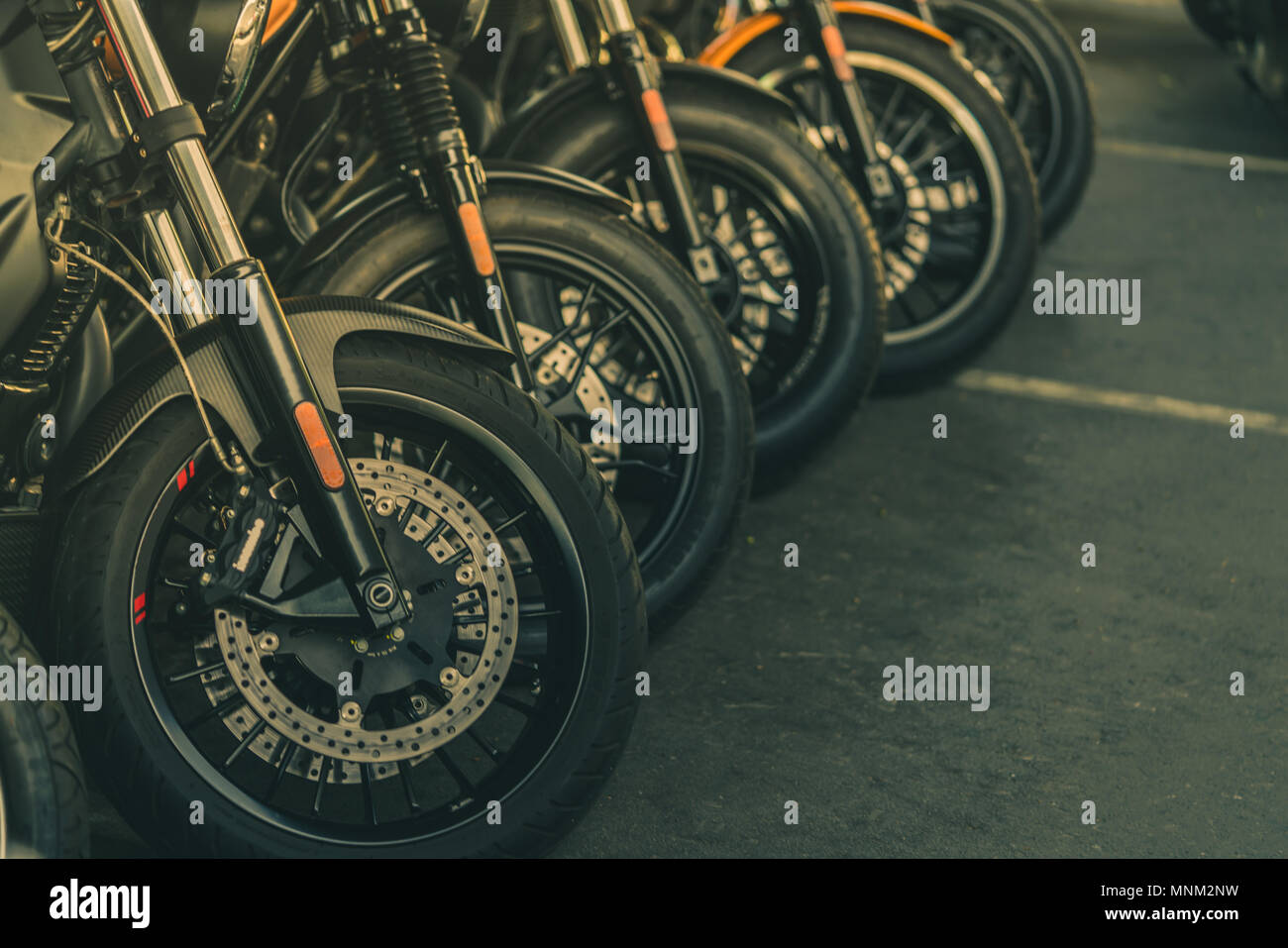 Closeup of new motorbike front wheel . Big bike parked on asphalt road ...