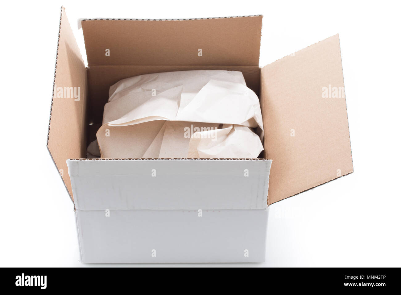 opened shipping carton with paper filling material, white background ...