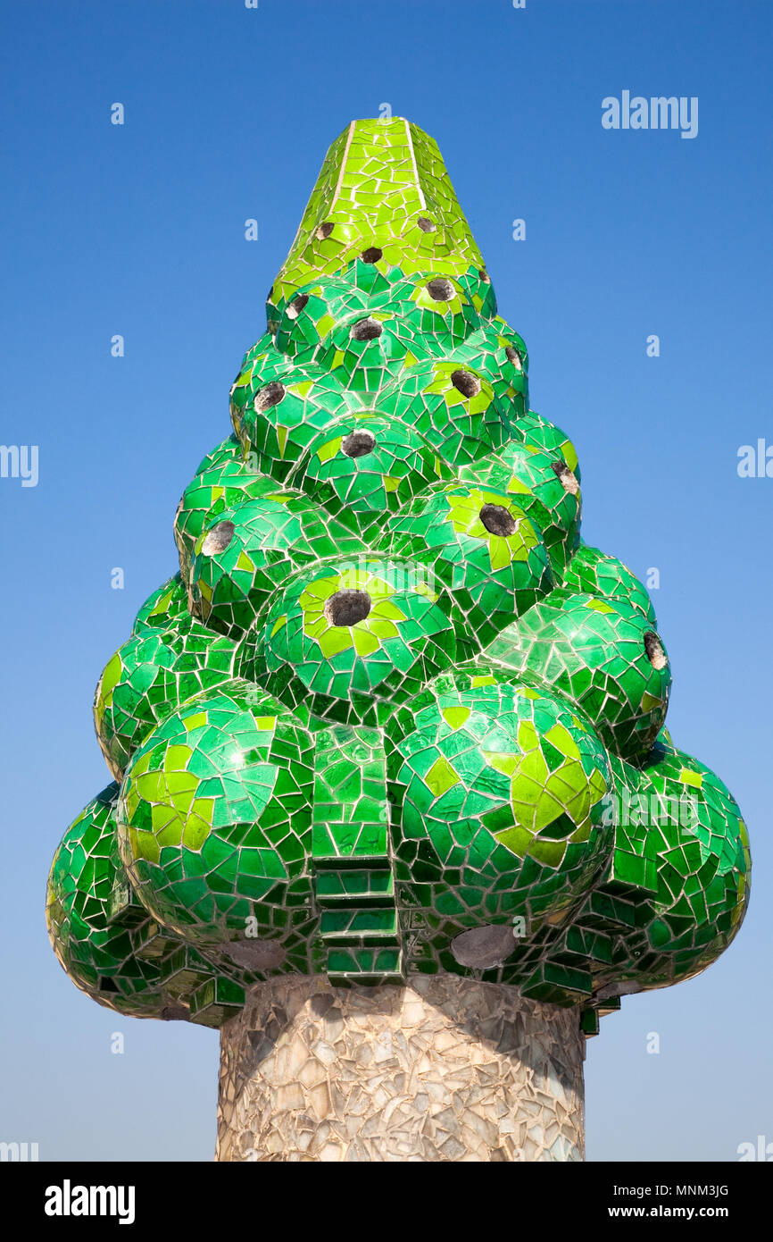 The green mosaic chimneys made of broken ceramic tiles on roof of Palau ...