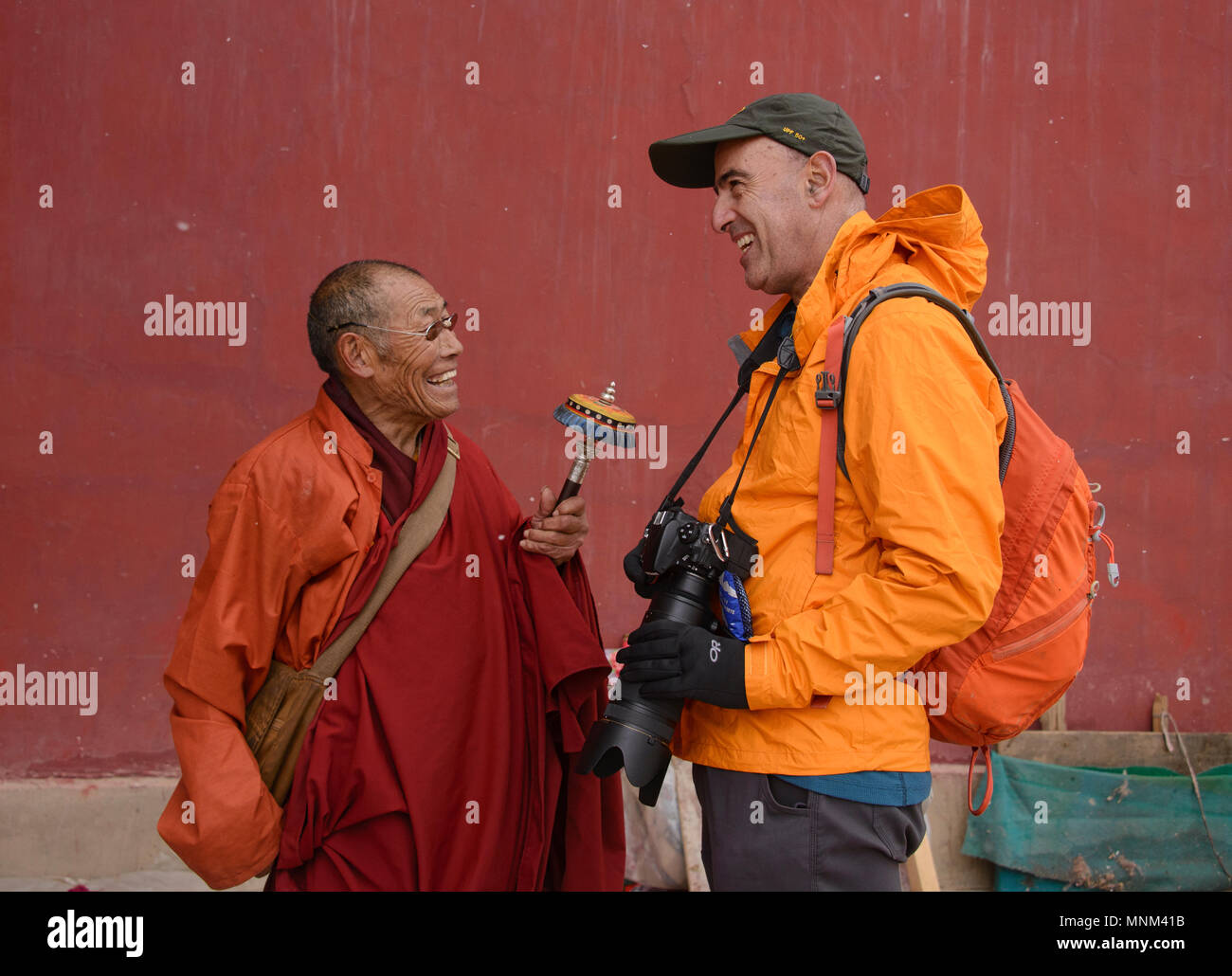 Friendly Tibetan monk talking to a tourist in Yarchen Gar, Sichuan ...
