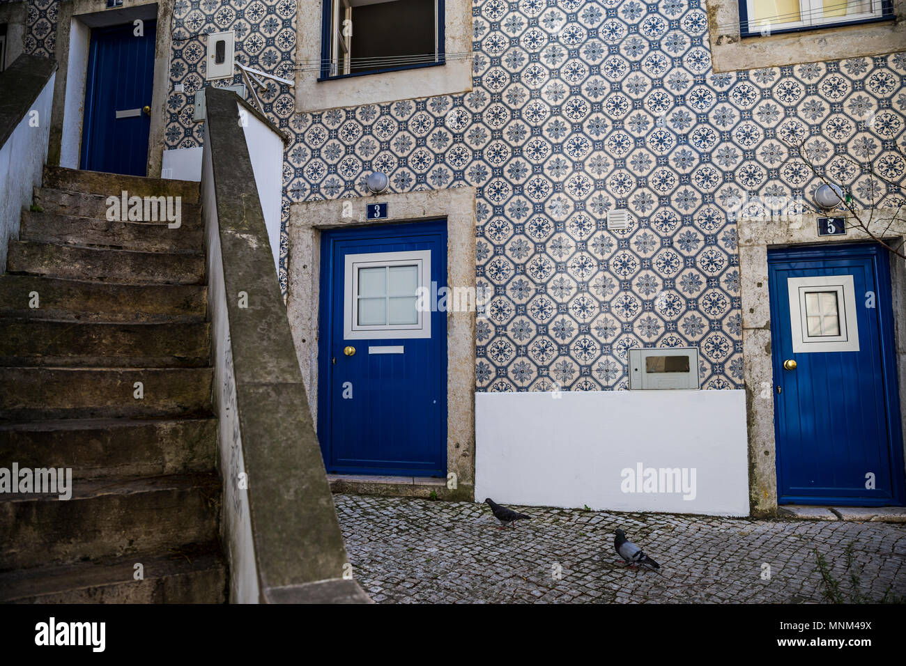 Tiled building facade and blue doors in Lisbon, Portugal Stock Photo ...