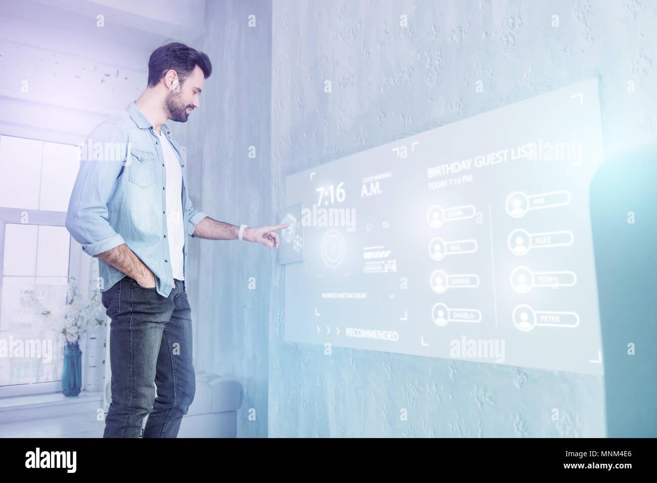 Young web developer touching a futuristic screen while working at home Stock Photo - Alamy