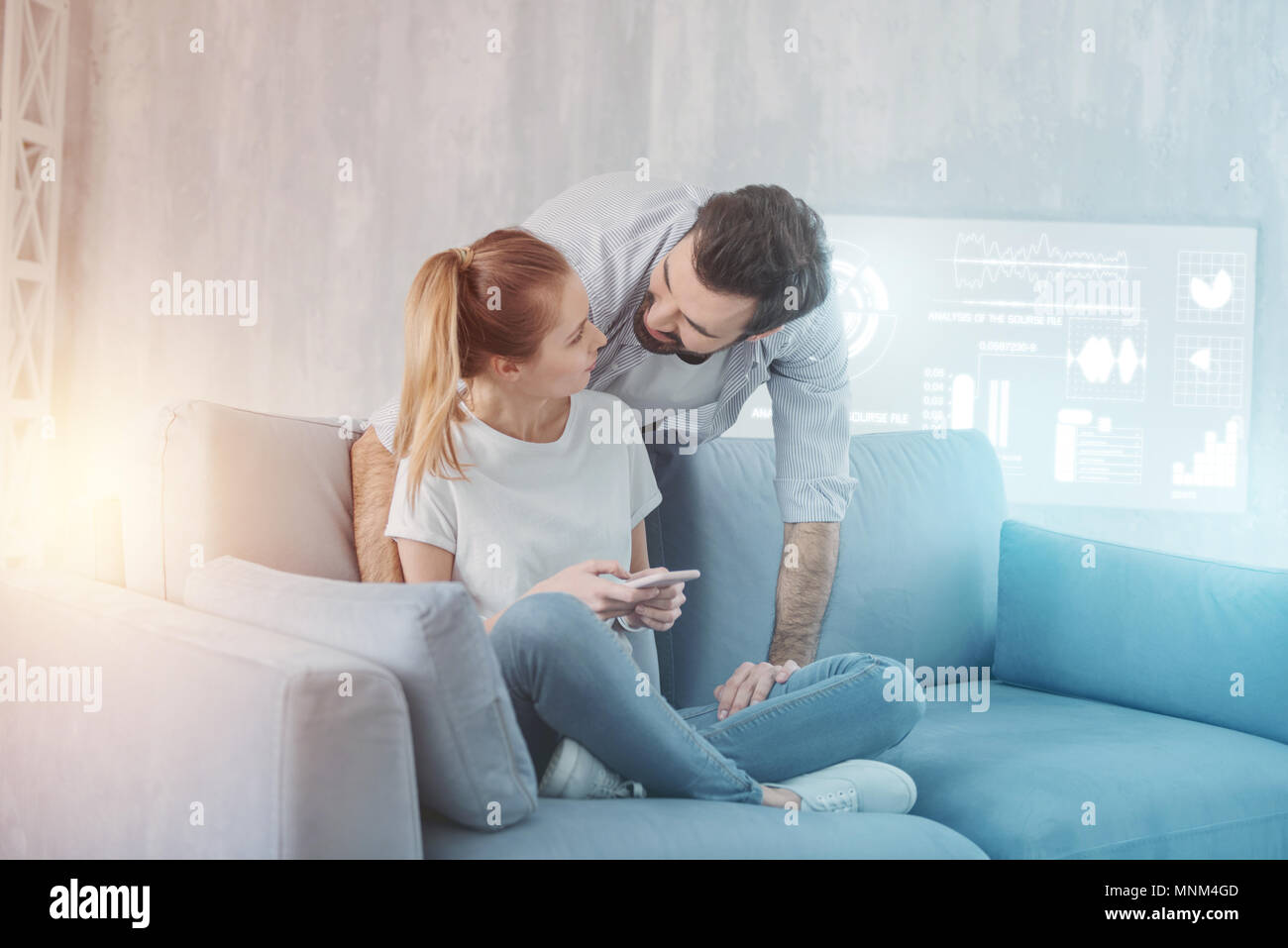 Attentive man leaning to his girlfriend and smiling Stock Photo - Alamy