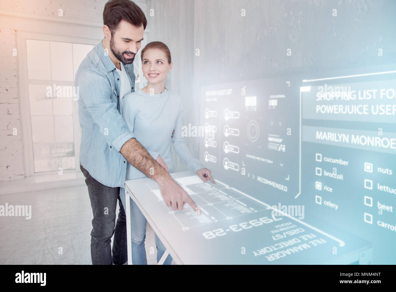 Young web designer pointing to the futuristic device Stock Photo - Alamy