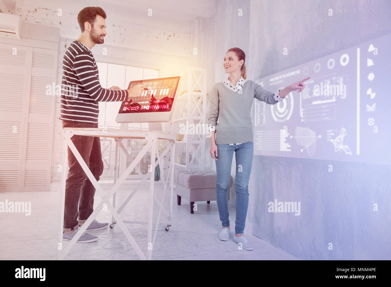 Emotional software developers smiling while working together Stock ...