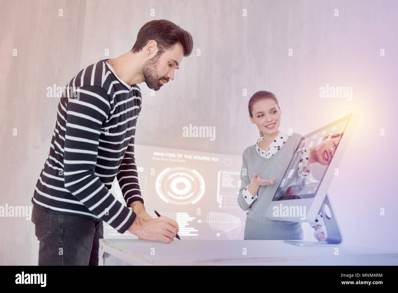 Software developer showing a computer while her colleague working Stock ...