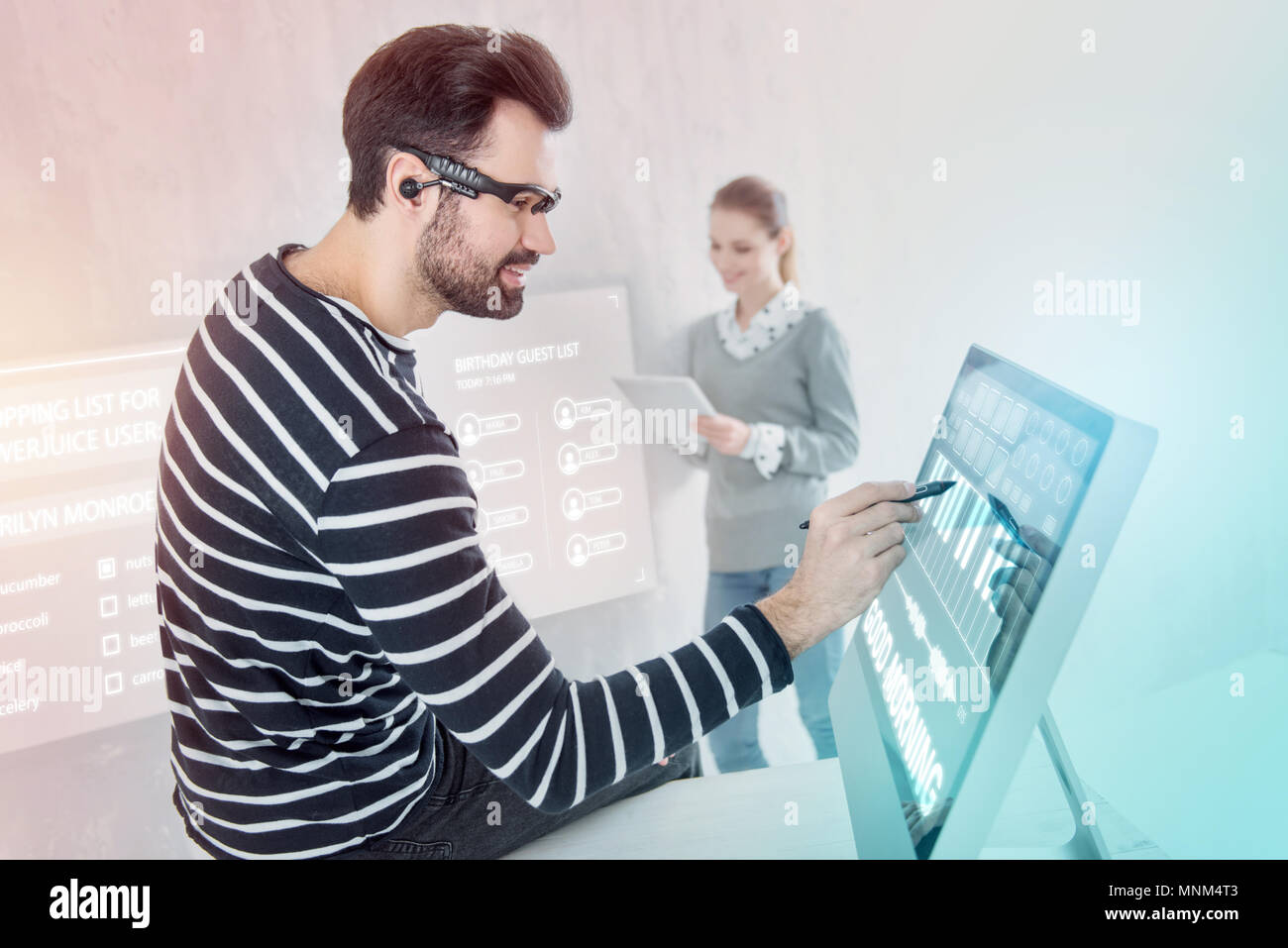 Calm programmer sitting on the table and working in his computer Stock ...