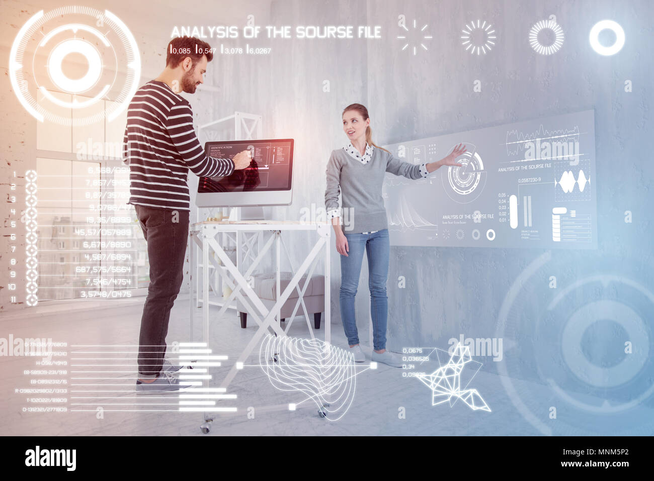 Creative programmer pointing to the screen while his colleague pointing ...