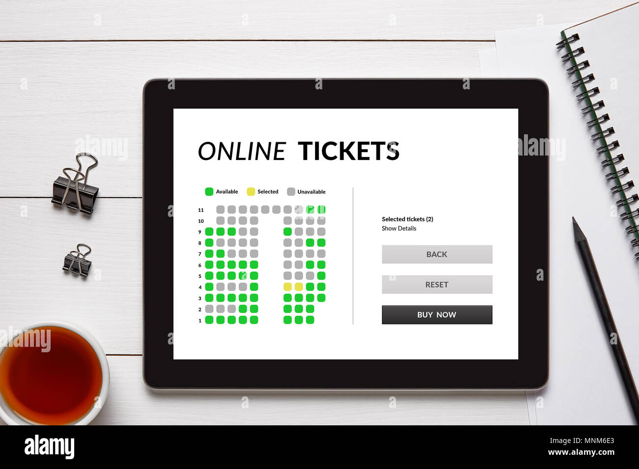 Online tickets concept on tablet screen with office objects on white ...