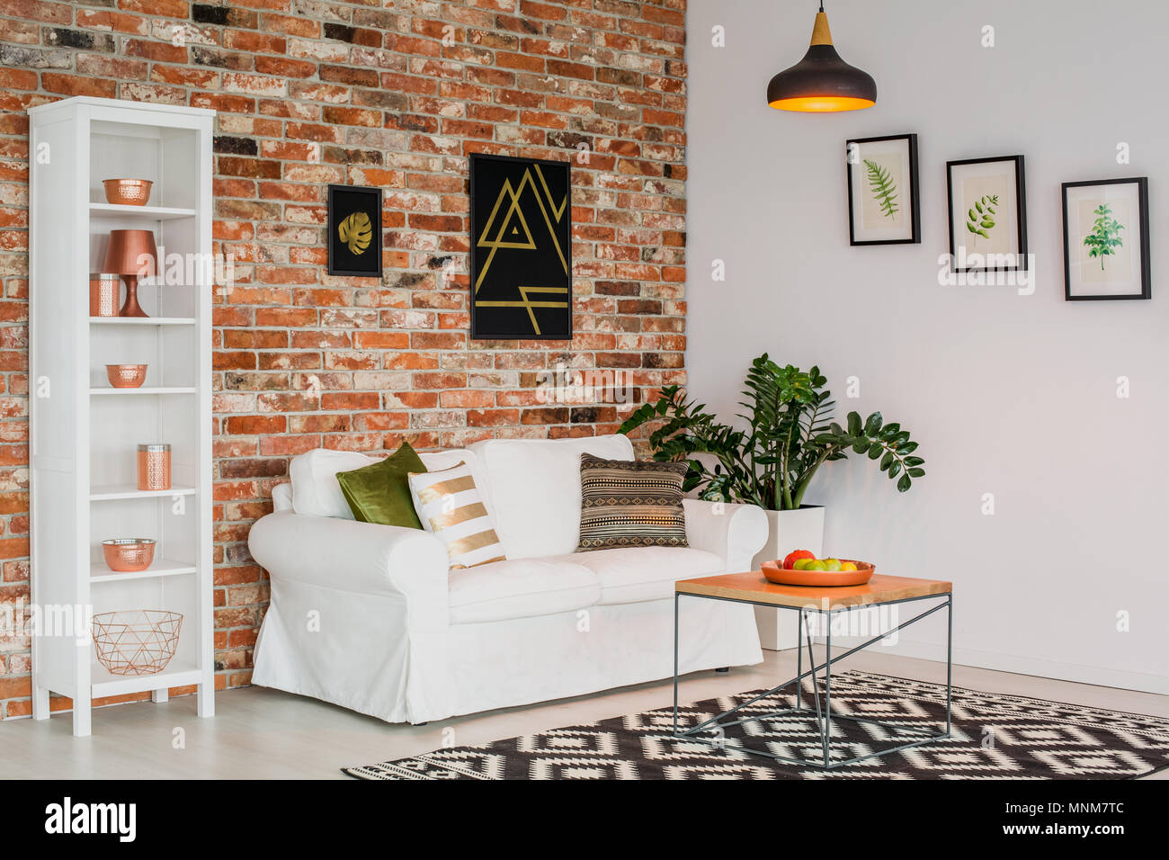 Simple living room with white furniture, brick wall and carpet Stock ...