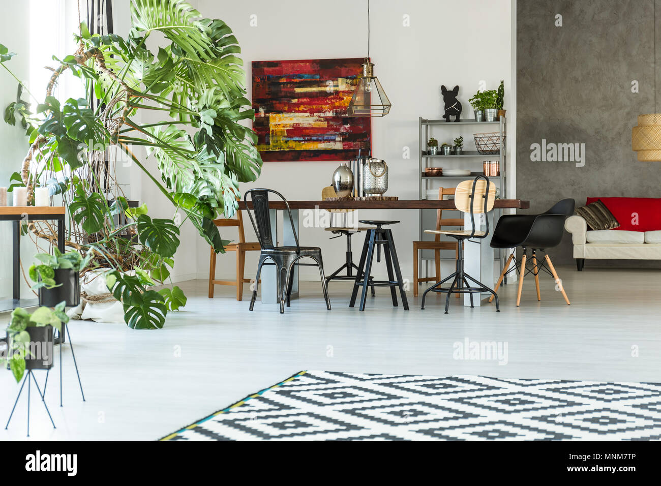 Modern, white interior with communal table, carpet, sofa and chairs ...