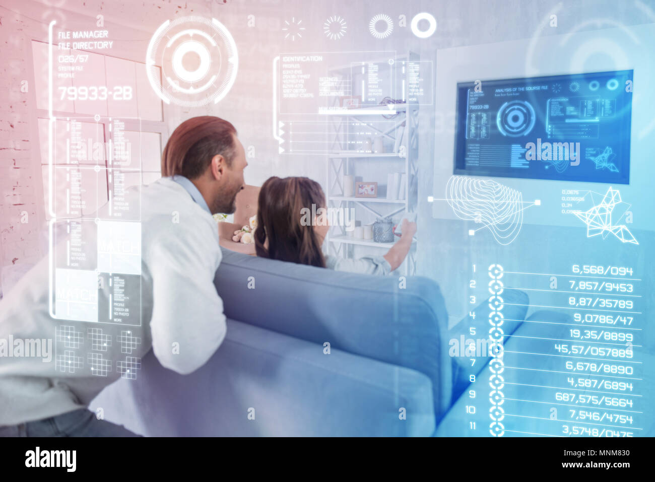 Friendly family switching channels while watching TV at home Stock ...