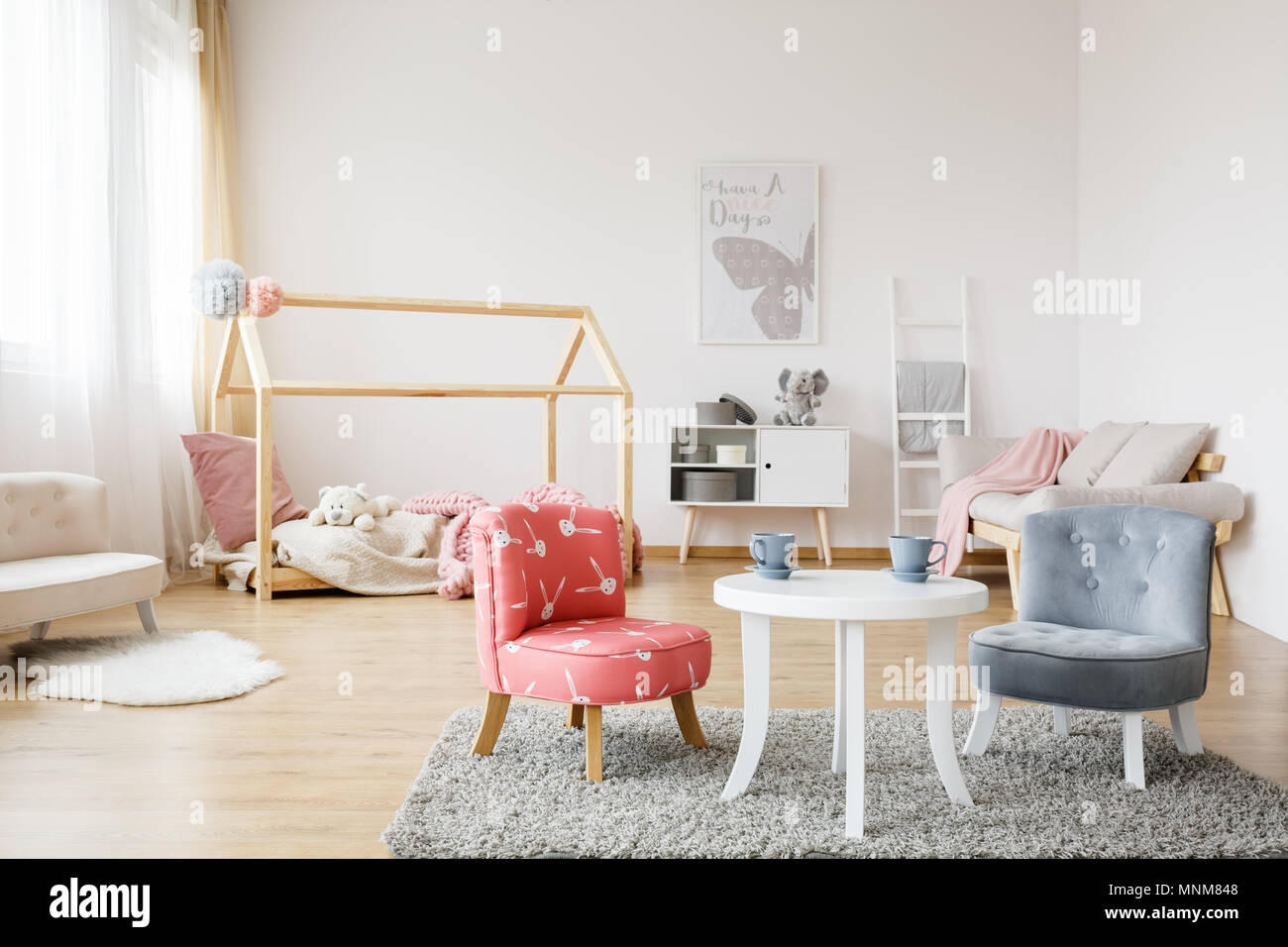 Two blue tea cups standing on white table in spacious kid room Stock ...