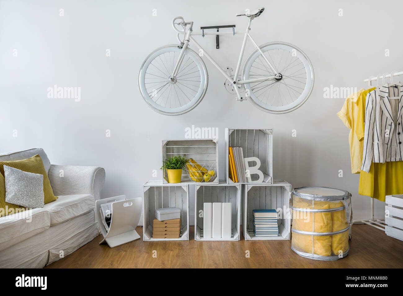 Modern stylish lounge with shelf of wooden boxes. White vintage bicycle ...