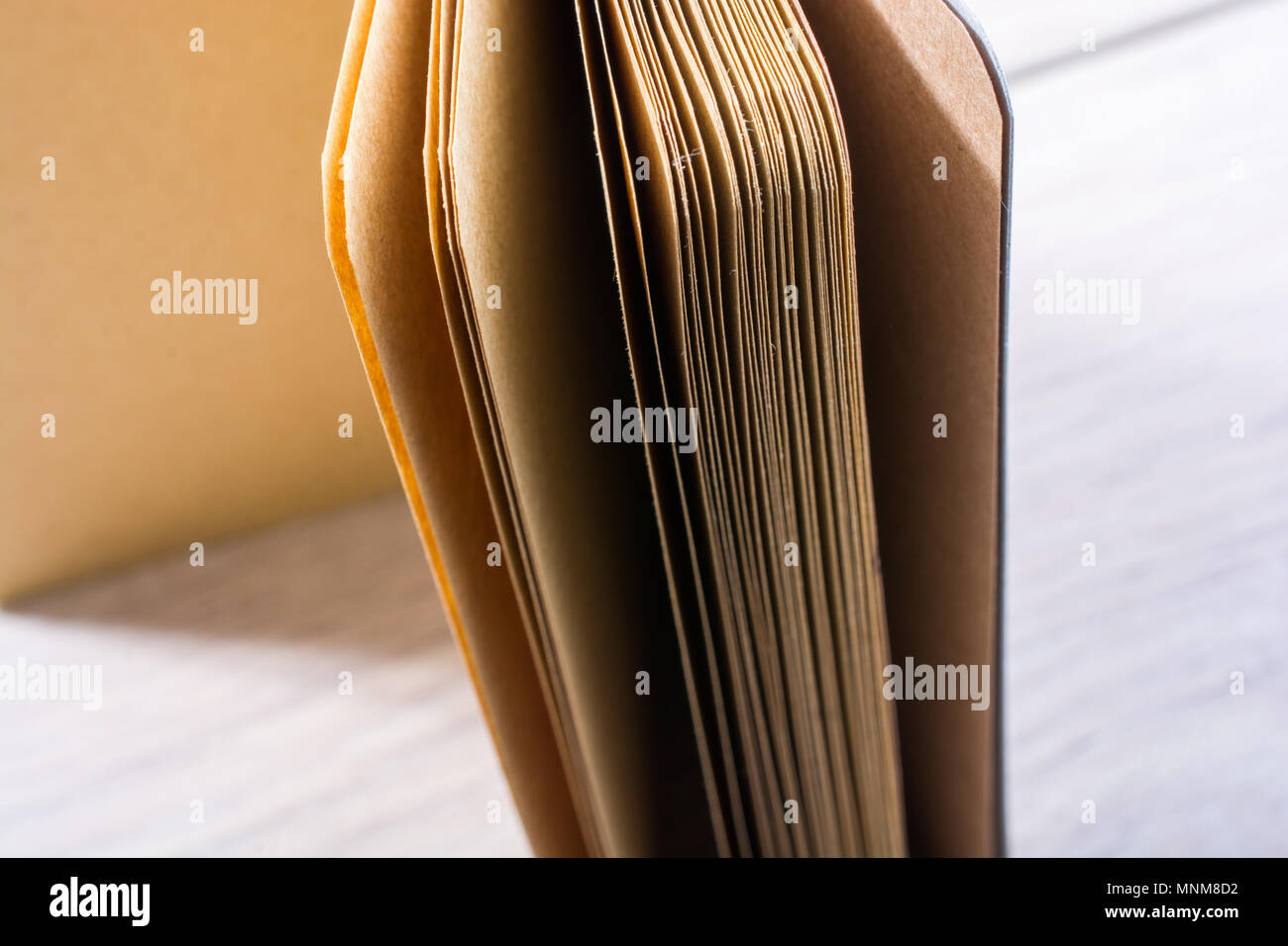 Brown color notebook open on a black background Stock Photo - Alamy