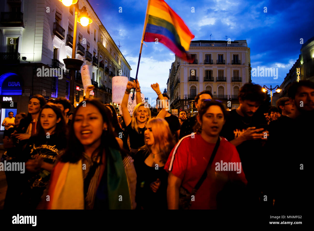 Demonstrators march at night carrying banners and posters with slogans ...