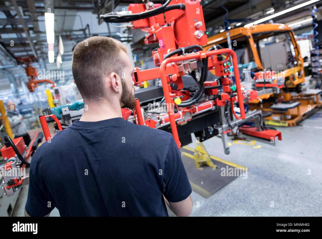 16 May 2018, Germany, Munich: Employees of MAN Truck & Bus work on a ...