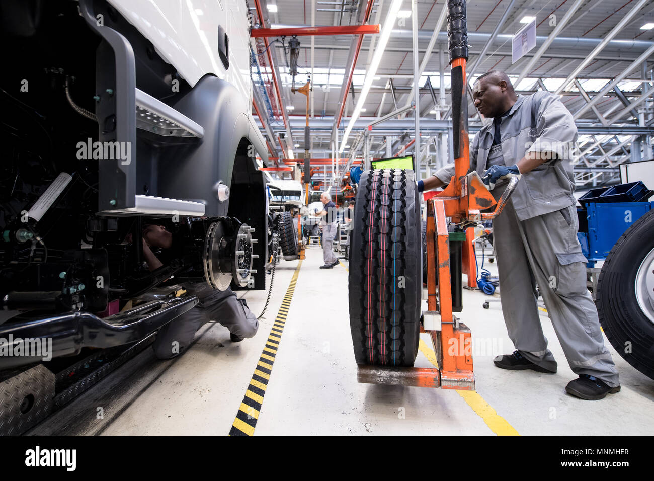 16 May 2018, Germany, Munich: Employees of MAN Truck & Bus work on a ...