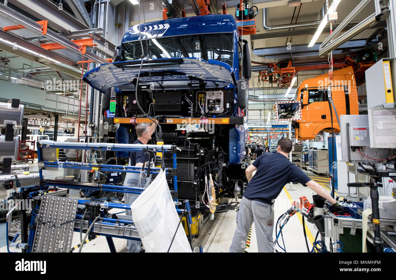 16 May 2018, Germany, Munich: Employees of MAN Truck & Bus work on a ...