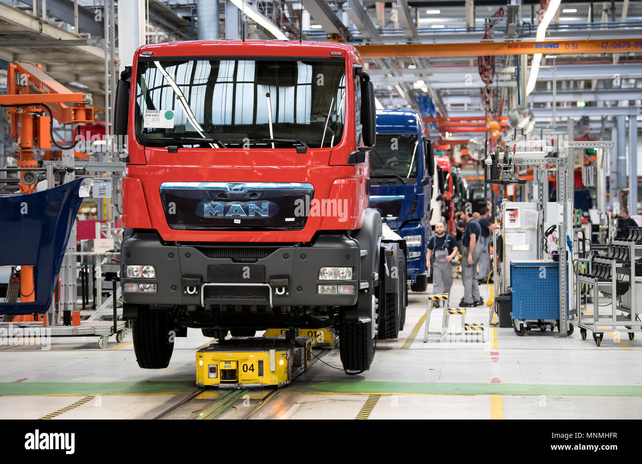 16 May 2018, Germany, Munich: Employees of MAN Truck & Bus work on a ...