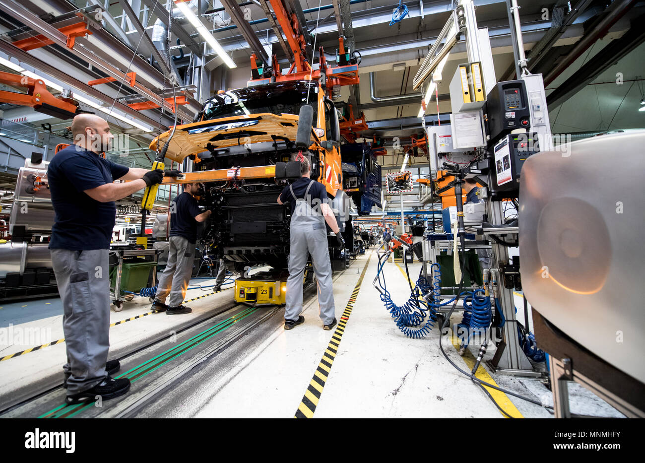 16 May 2018, Germany, Munich: Employees of MAN Truck & Bus work on a ...
