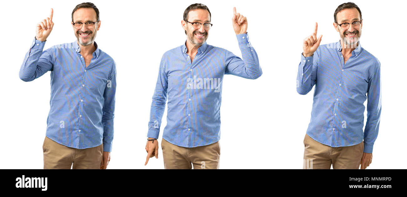 Middle age handsome man raising his finger, the number one over white ...