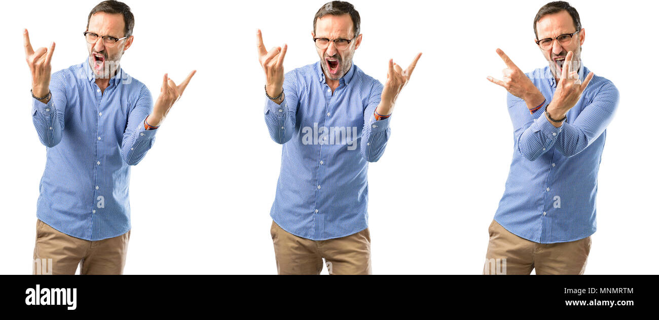 Middle age handsome man making rock symbol with hands, shouting and ...