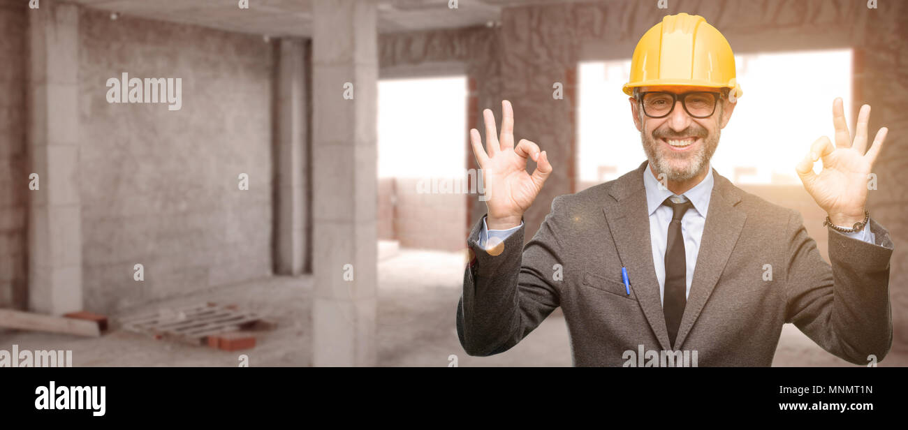 Senior architect or engineer doing ok sign gesture with both hands ...