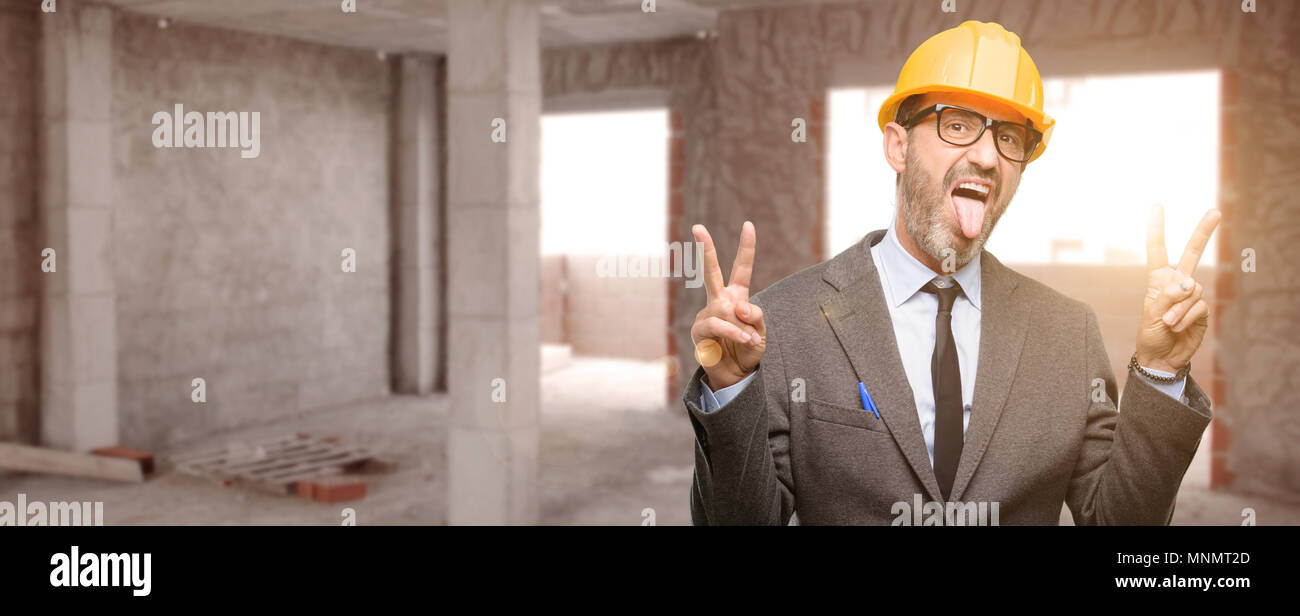 Senior architect or engineer looking at camera showing tong and making ...